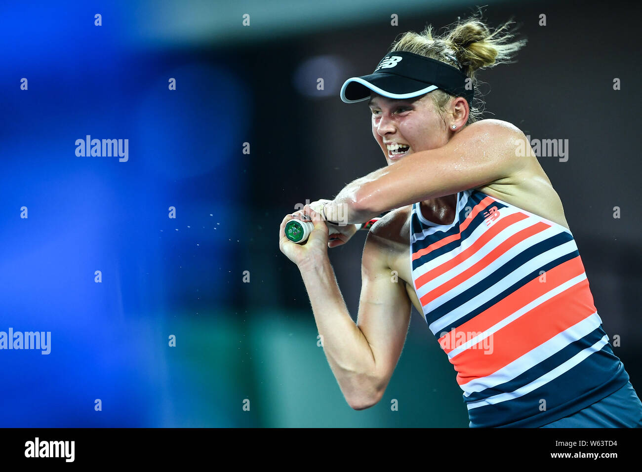 Fiona Ferro of France returns a shot to Wang Qiang of China in their ...