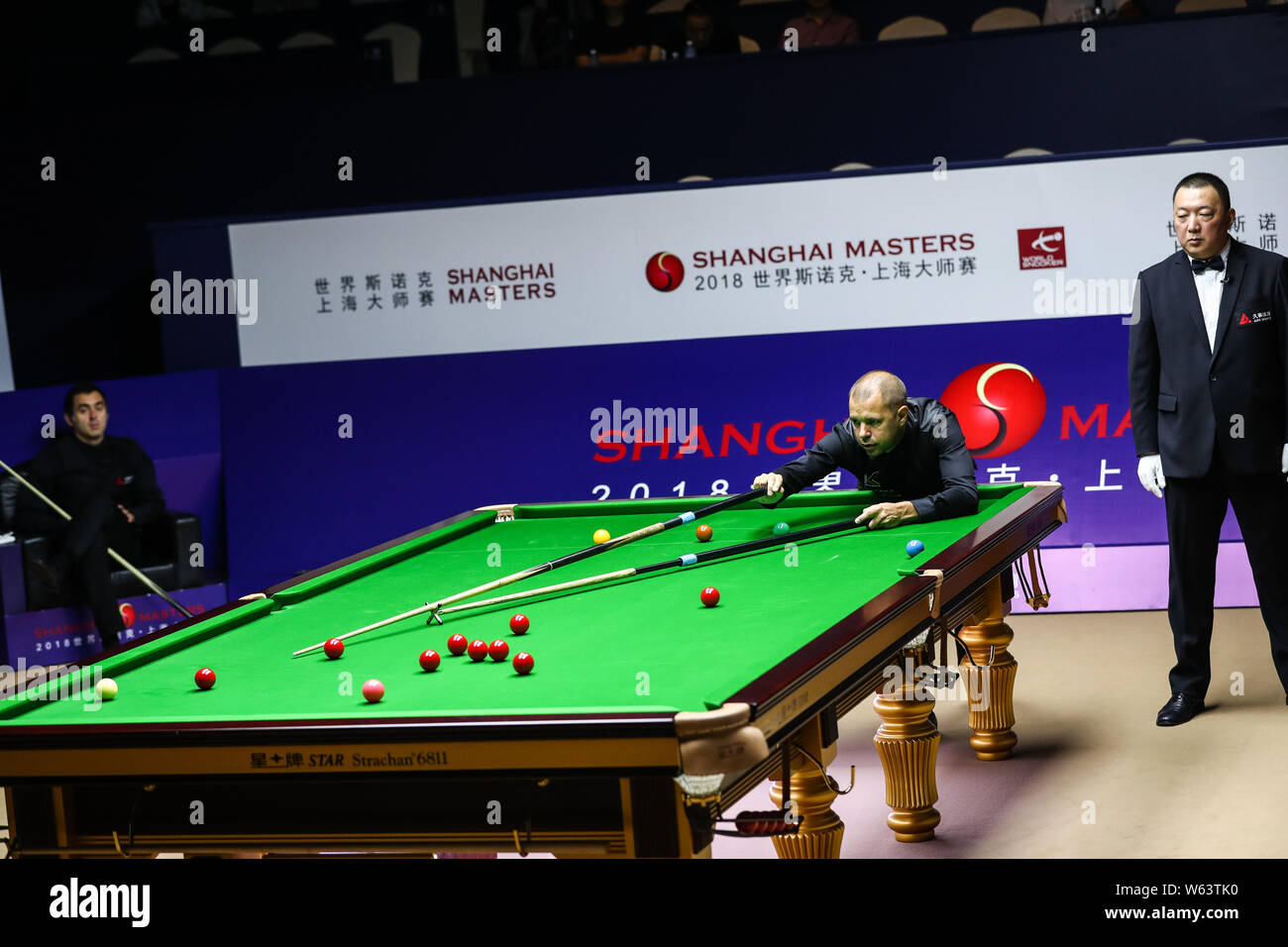 Barry Hawkins of England plays a shot to Ronnie O'Sullivan of England ...