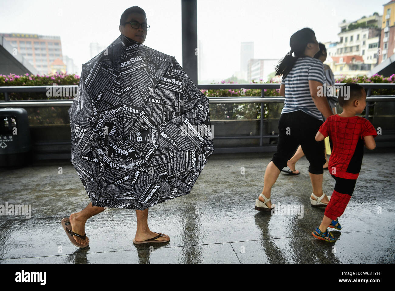 Pedestrians braves strong wind caused by Typhoon Mangkhut, the 22nd ...