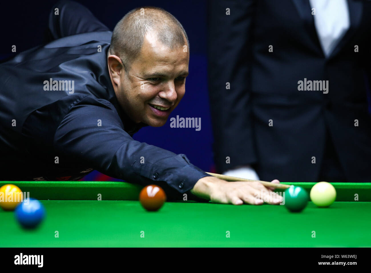Barry Hawkins of England plays a shot to Mark Williams of Wales in ...