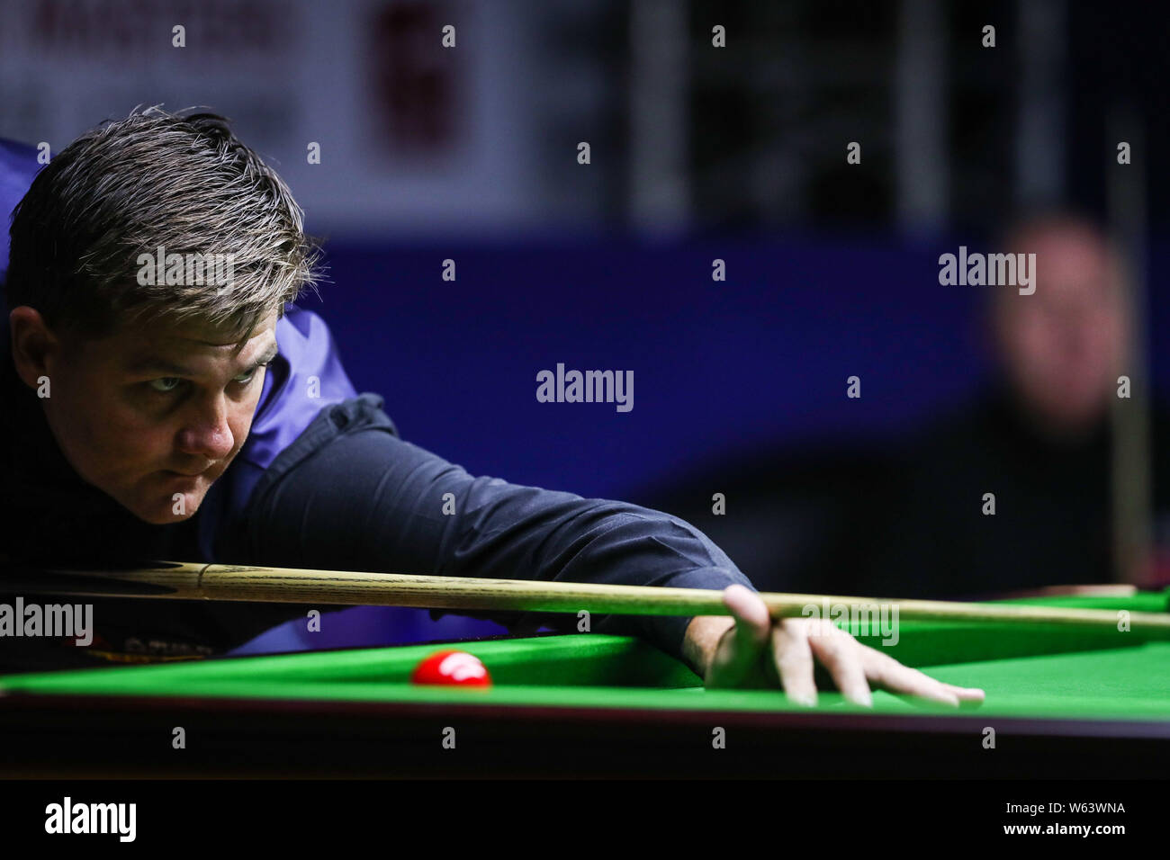 Ryan Day of Wales plays a shot to John Higgins of Scotland in their ...