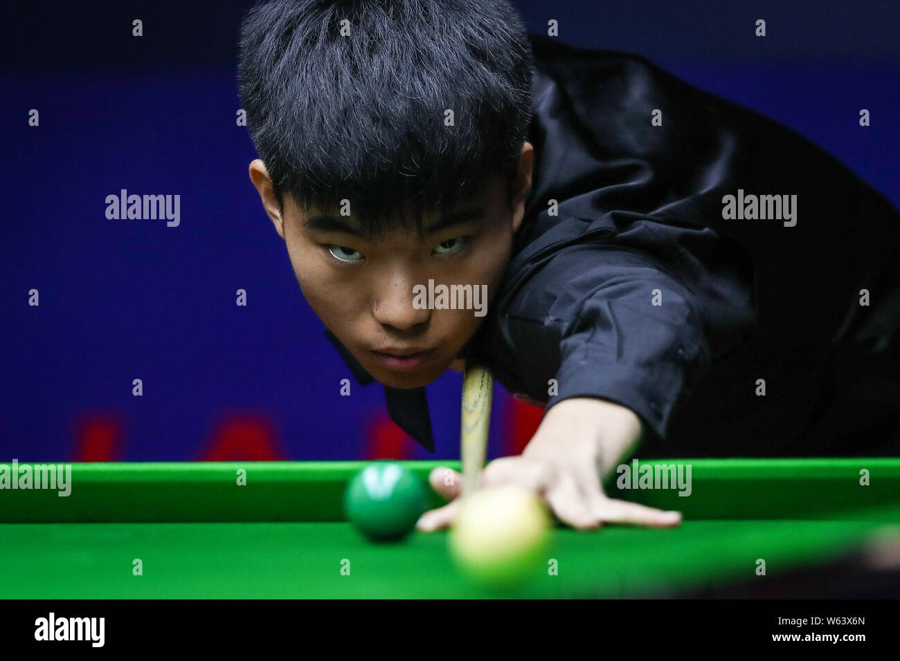 Fan Zhengyi of China plays a shot to Stuart Bingham of England in their ...
