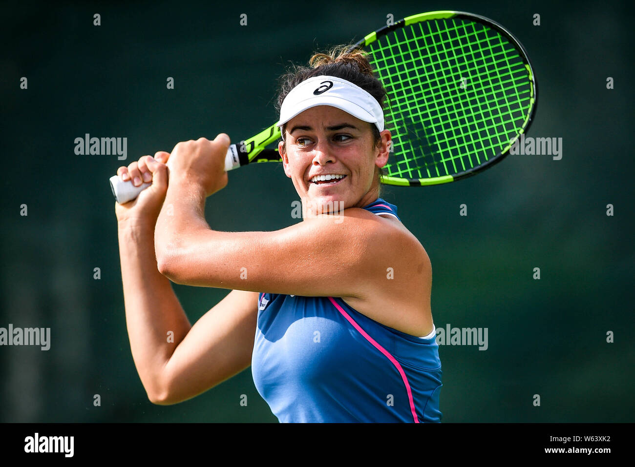 Jennifer Brady of the United States returns a shot to Alize Cornet of ...