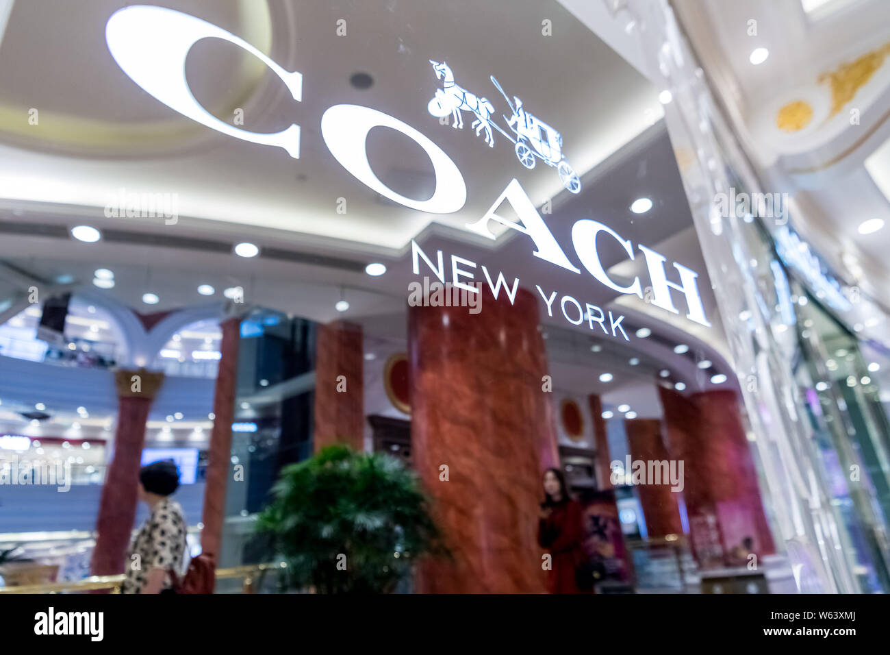 --FILE--Customers walk past a Coach New York store at a shopping mall ...