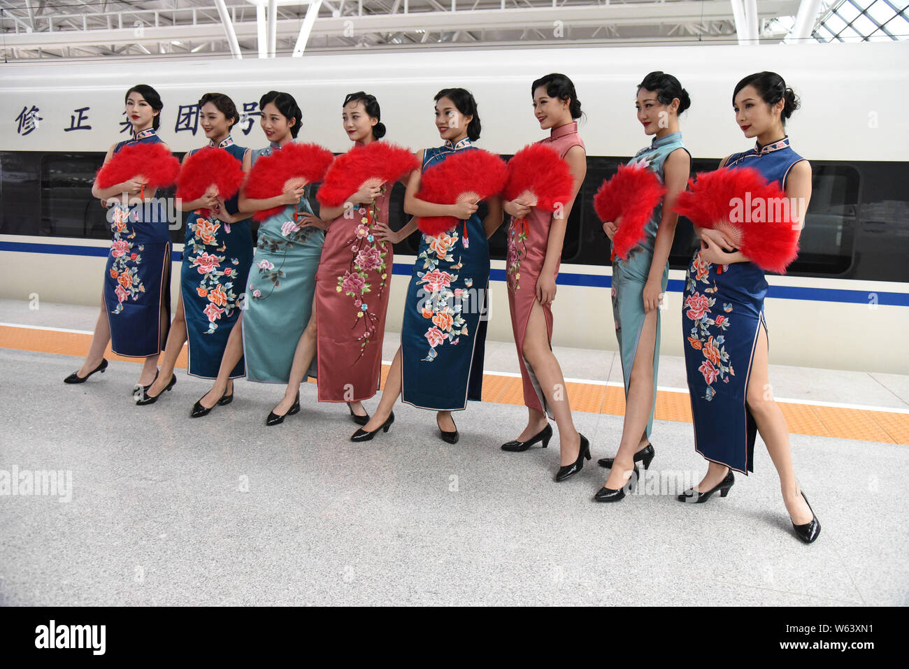 A dozen of artists in colorful cheongsam, also known as qipao in ...