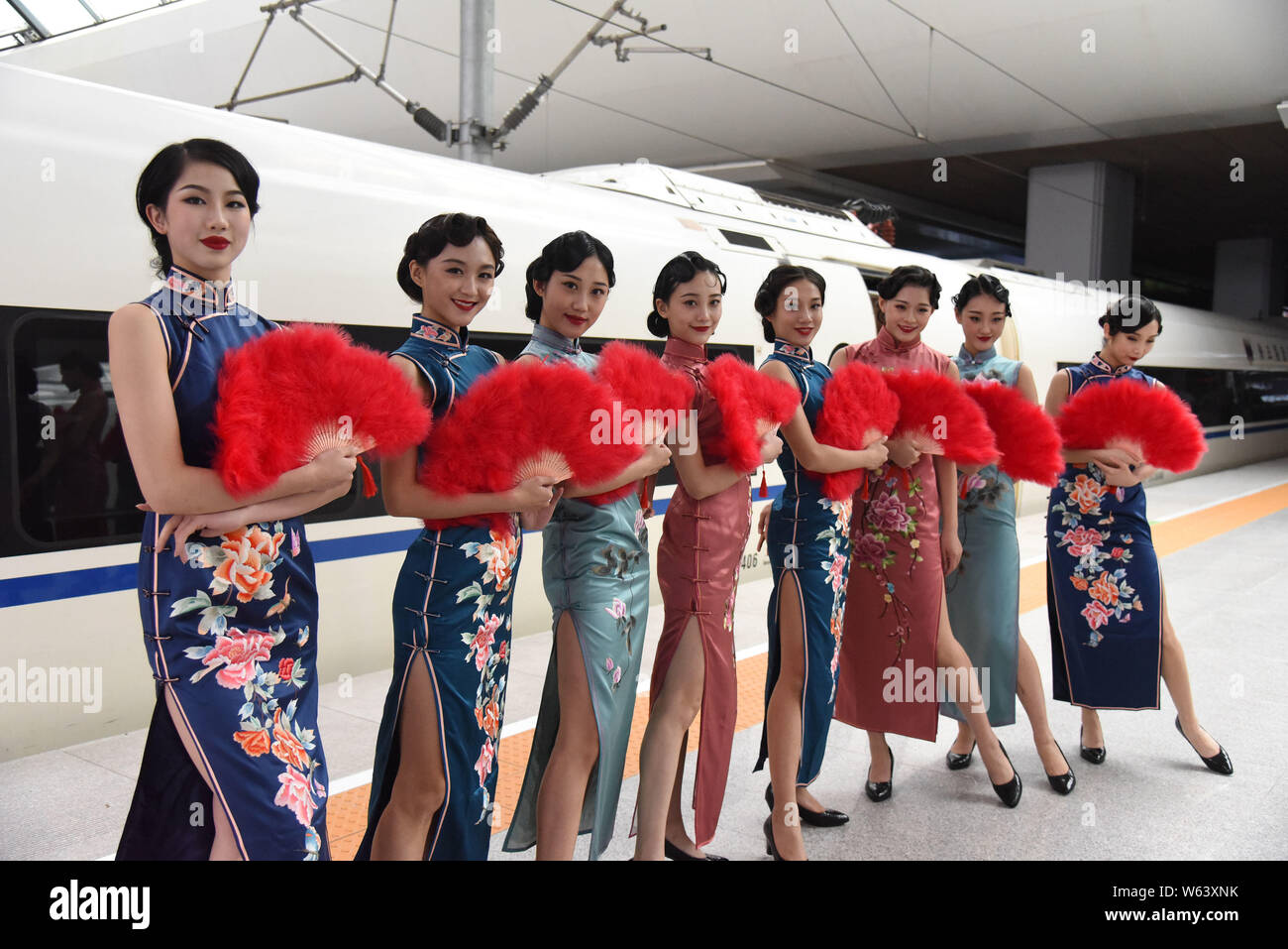 A dozen of artists in colorful cheongsam, also known as qipao in ...