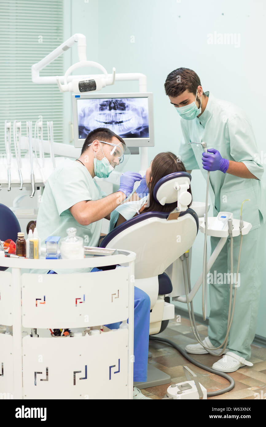 Doctor Dentist with an assistant work in a dental clinic Stock Photo ...