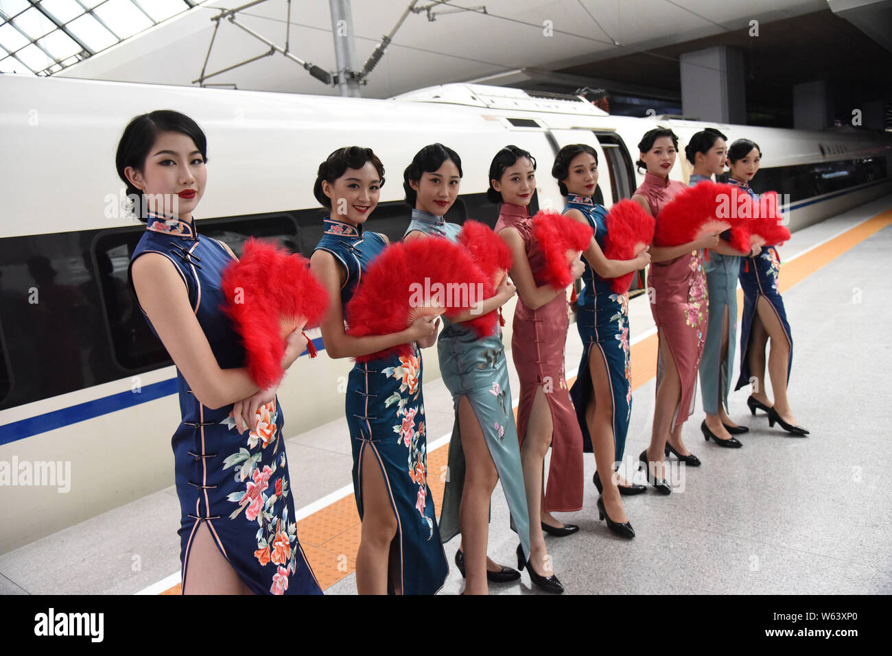 A dozen of artists in colorful cheongsam, also known as qipao in ...