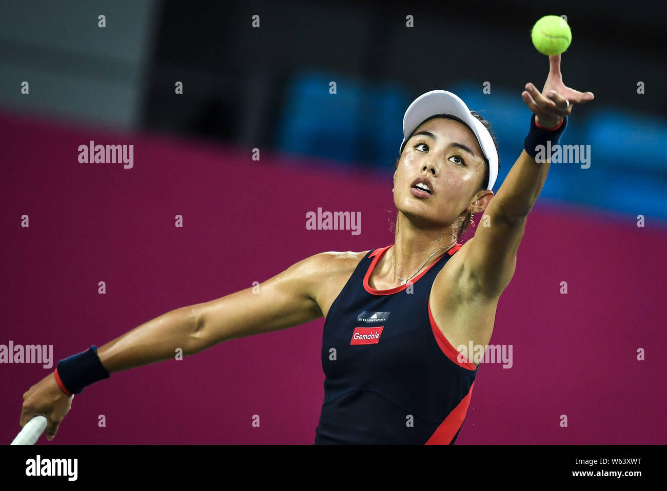 Wang Qiang of China serves against Andrea Petkovic of Germany in their semifinal match during ...