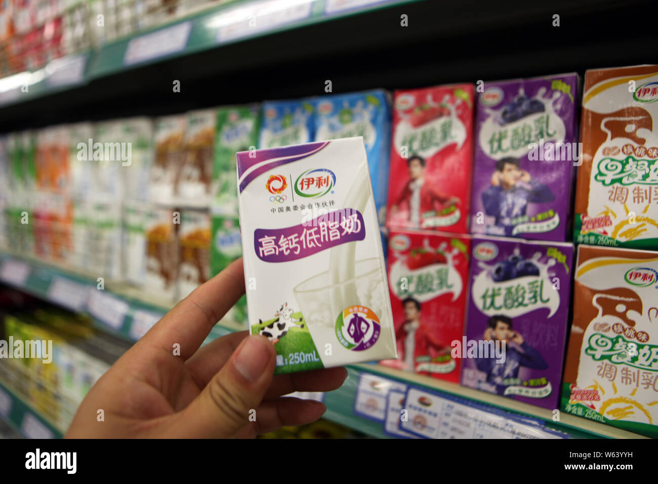 --FILE--A customer chooses a carton of Yili milk at a supermarket in ...