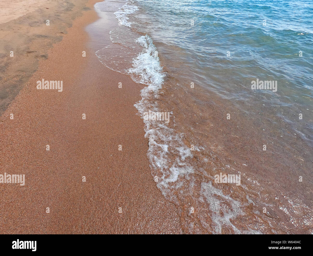 The texture of clear water with sandy bottom. Wave on the seashore or ...