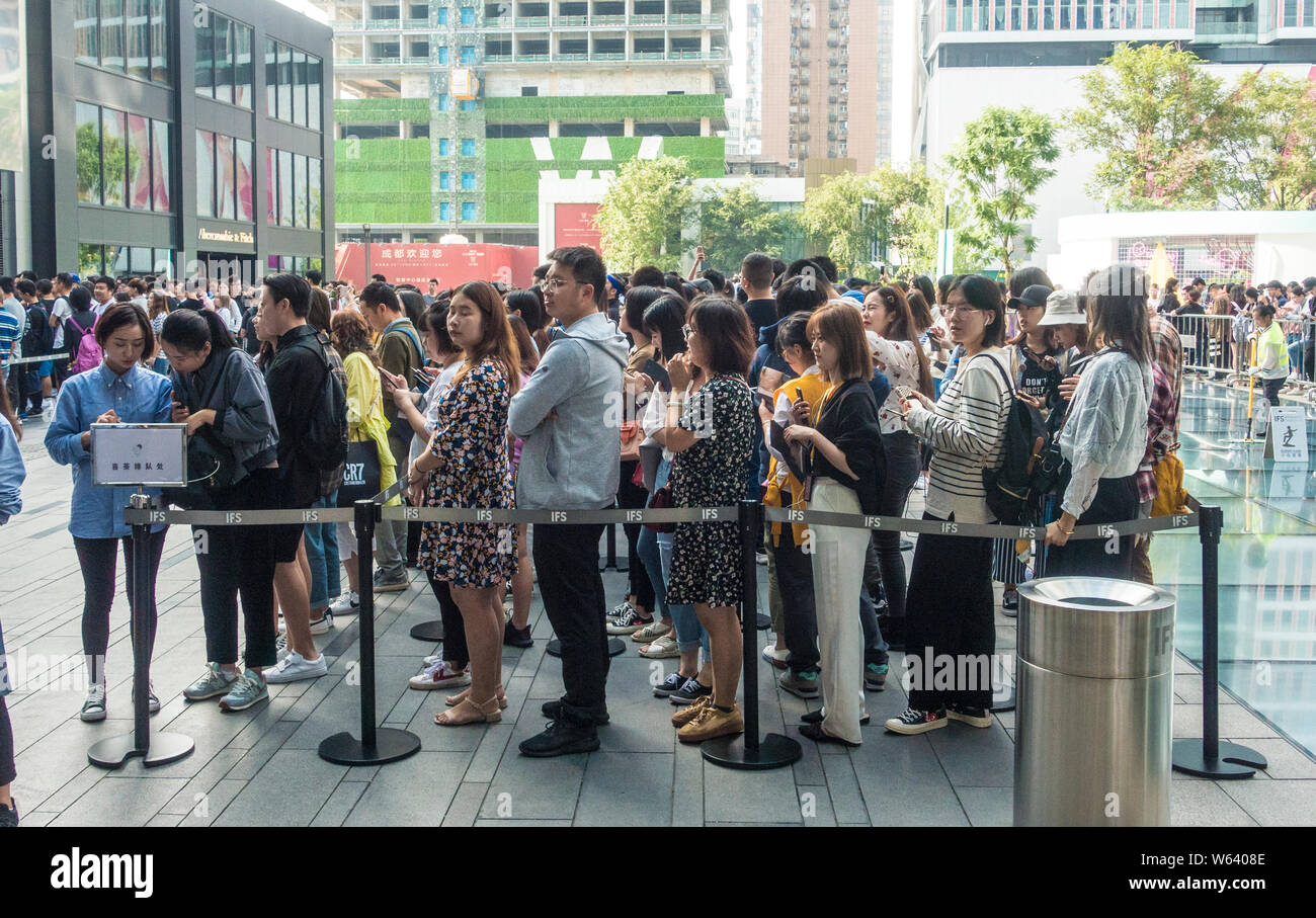 Chinese customers queue up to buy cheese tea at a branch of HEYTEA, a ...