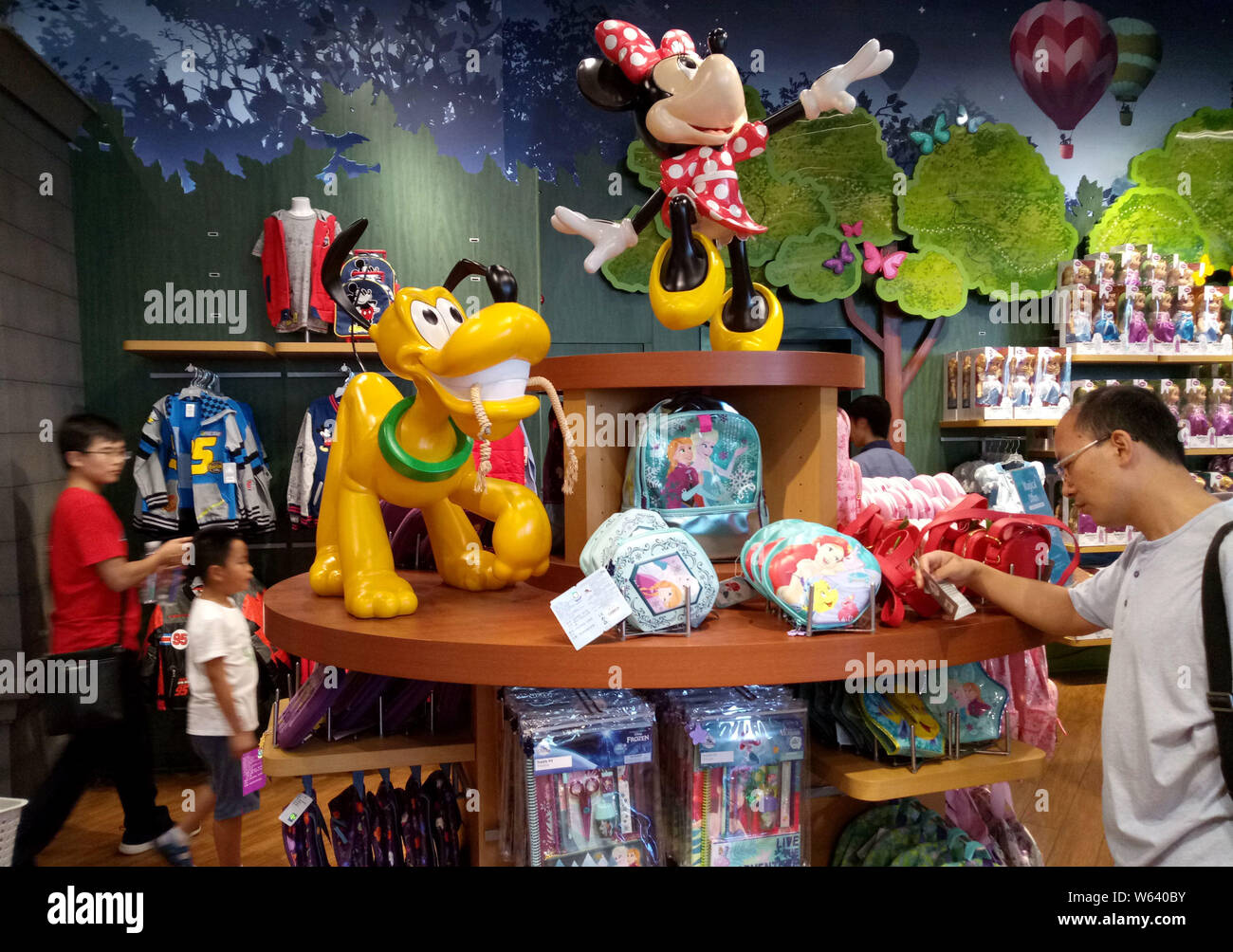 --FILE--Customers shop for toys, souvenirs and other Disney-licensed ...