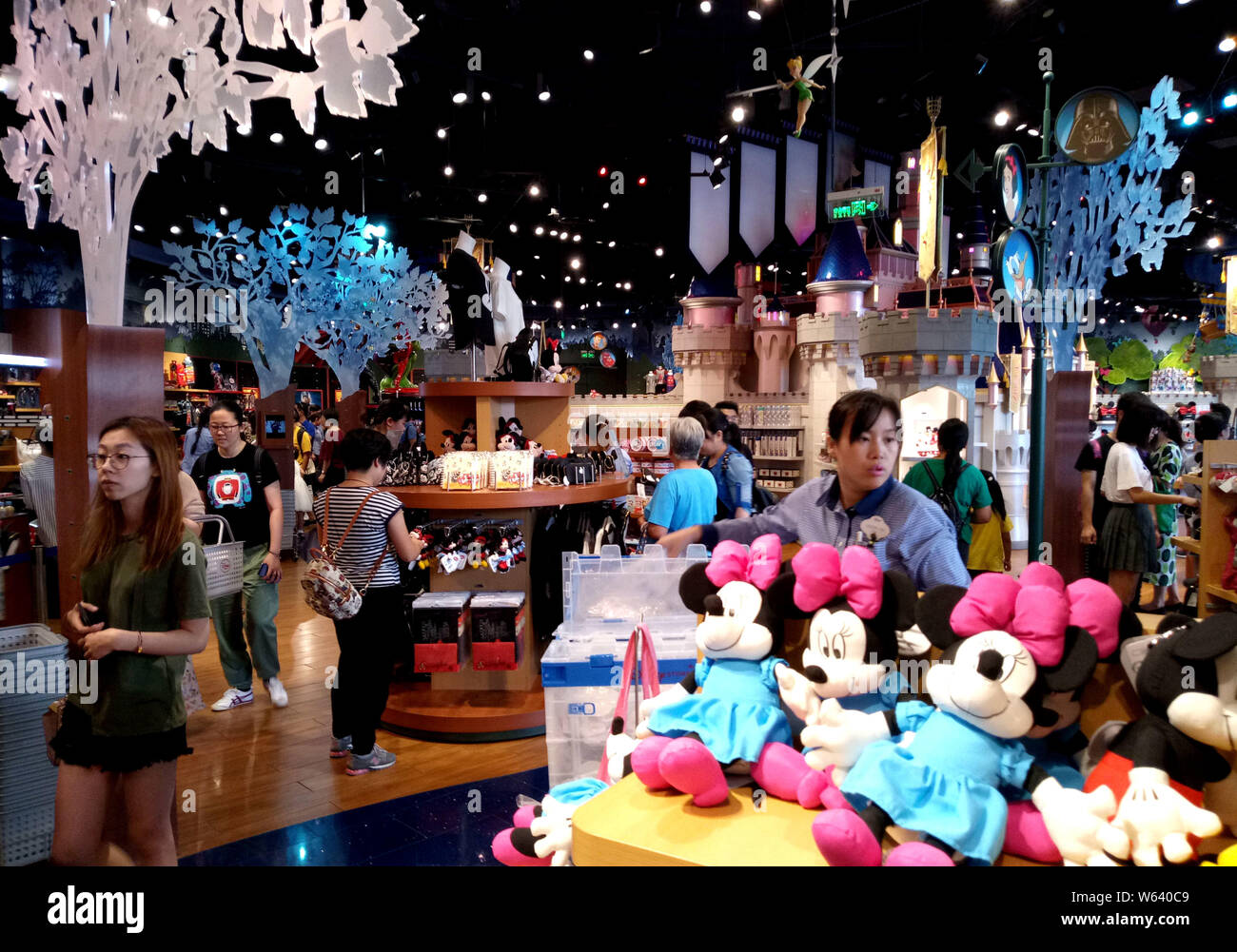 --FILE--Customers shop for toys, souvenirs and other Disney-licensed ...