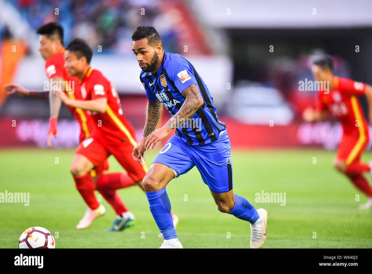 Brazilian football player Alex Teixeira of Jiangsu Suning dribbles ...