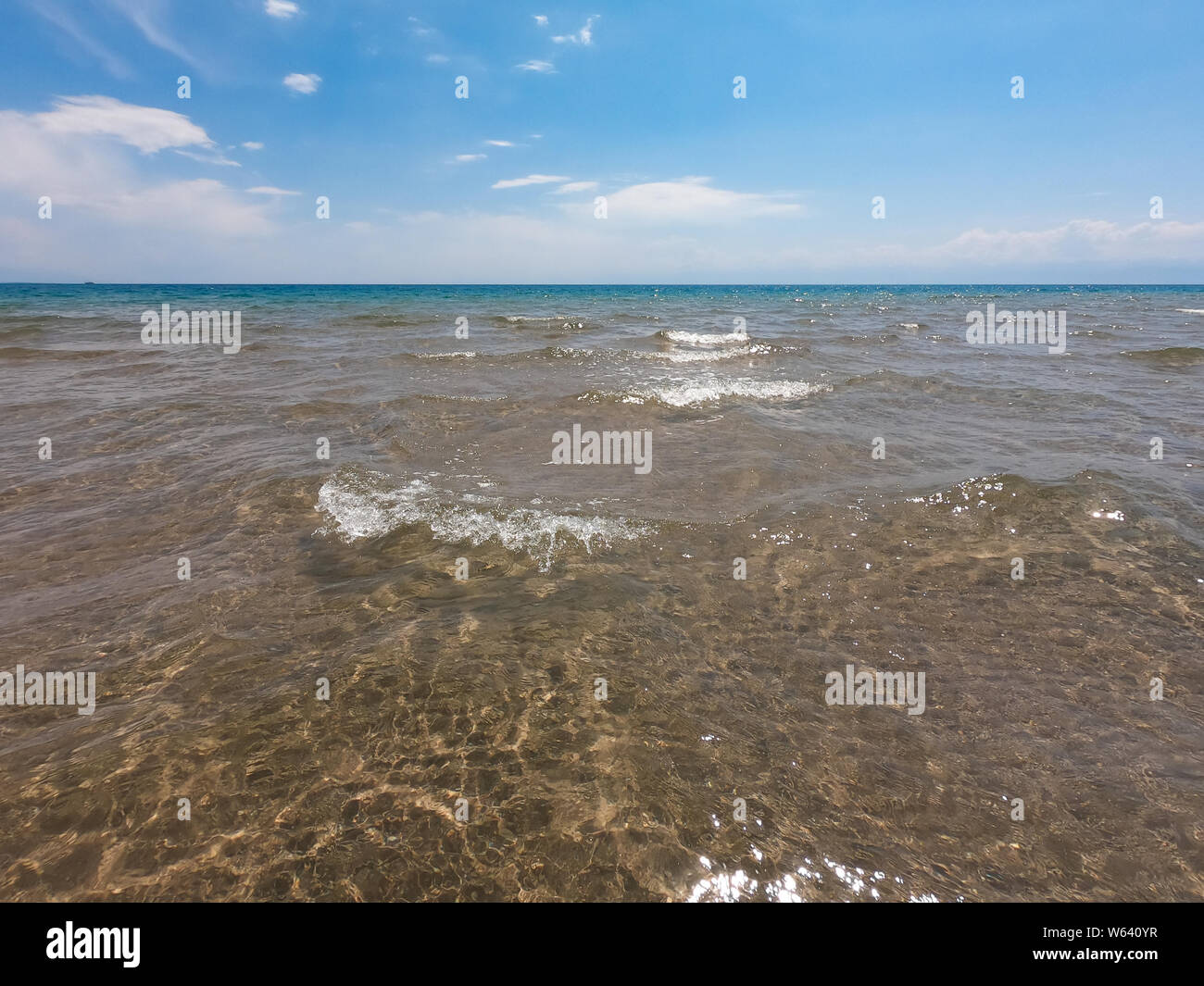 The texture of clear water with sandy bottom. Wave on the seashore or ...