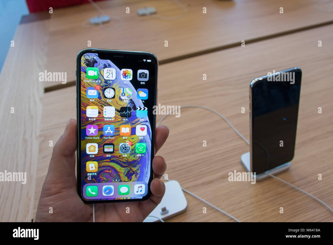 An iPhone XS smartphone and an iPhone XS Max smartphone are on display ...