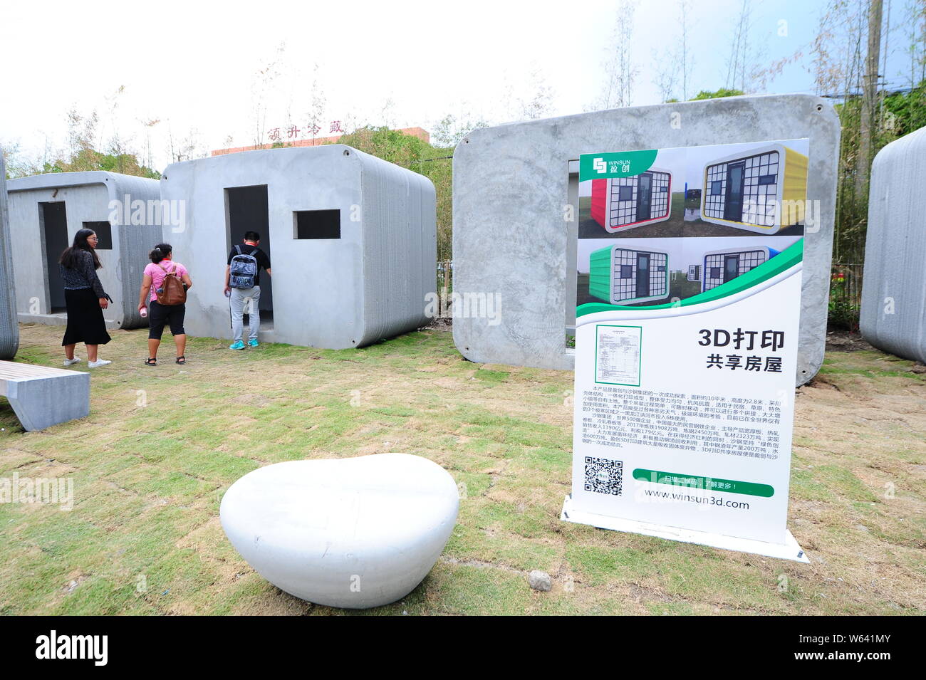3D-printed houses are on display during the 3D Printing Industry Expo ...