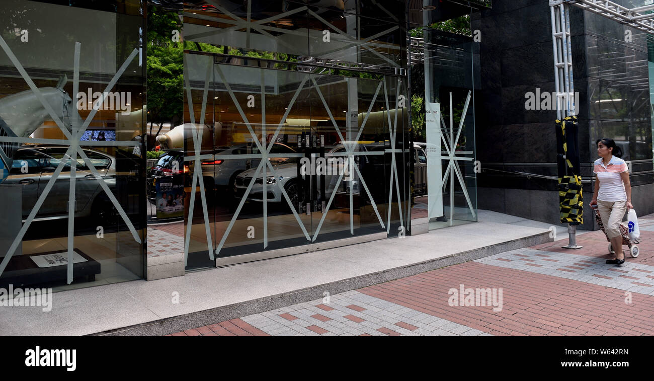 Windows of a building are taped up in preparation for the Typhoon ...