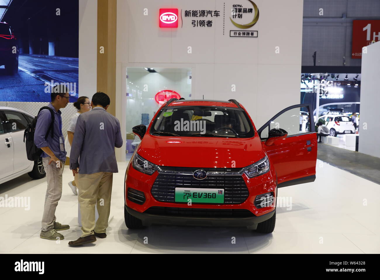 Chinese visitors view or try out a BYD Yuan EV360 electric car on display during the 20th China ...