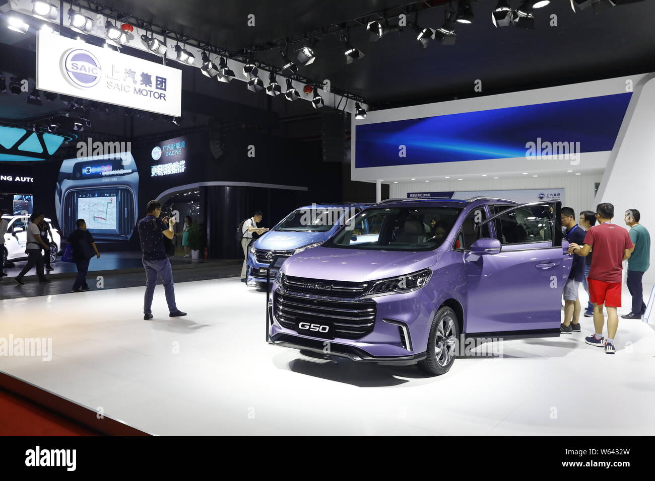 Chinese visitors view or try out Maxus electric cars of SAIC Motor on ...