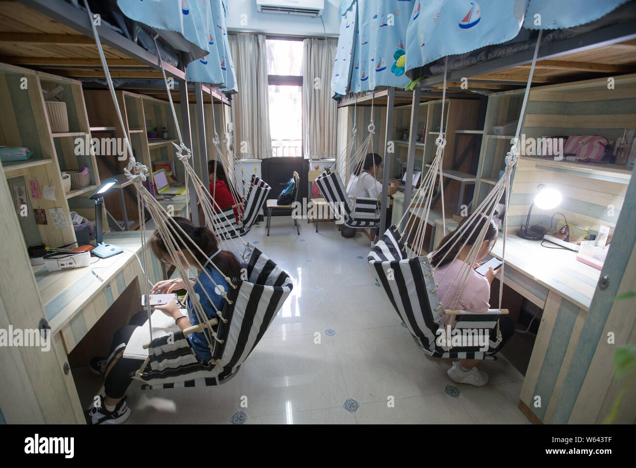 Students rest or study in their themed dormitory room at Hangzhou ...