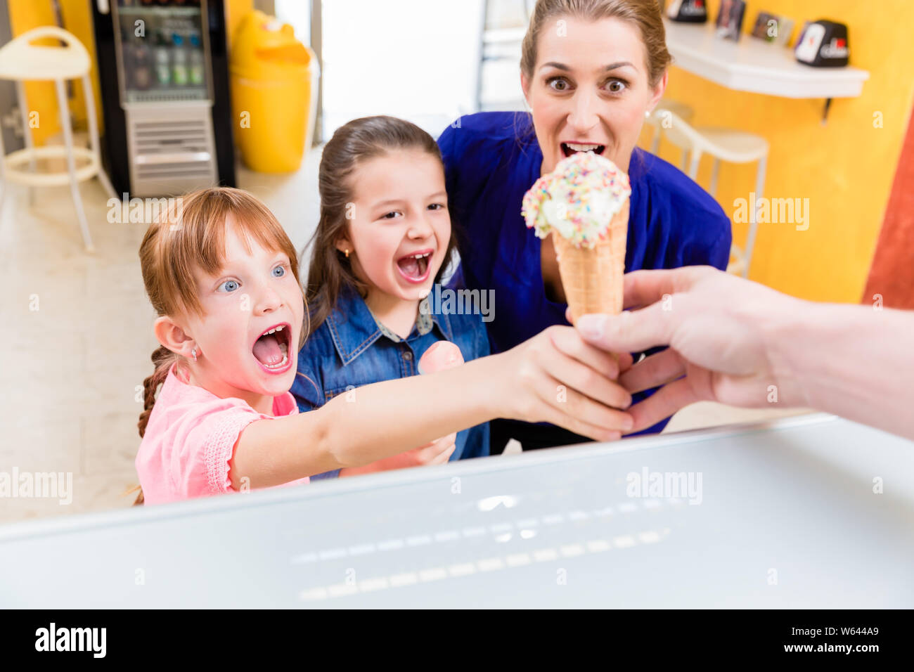 Little girls getting a cool ice on a hot day Stock Photo - Alamy