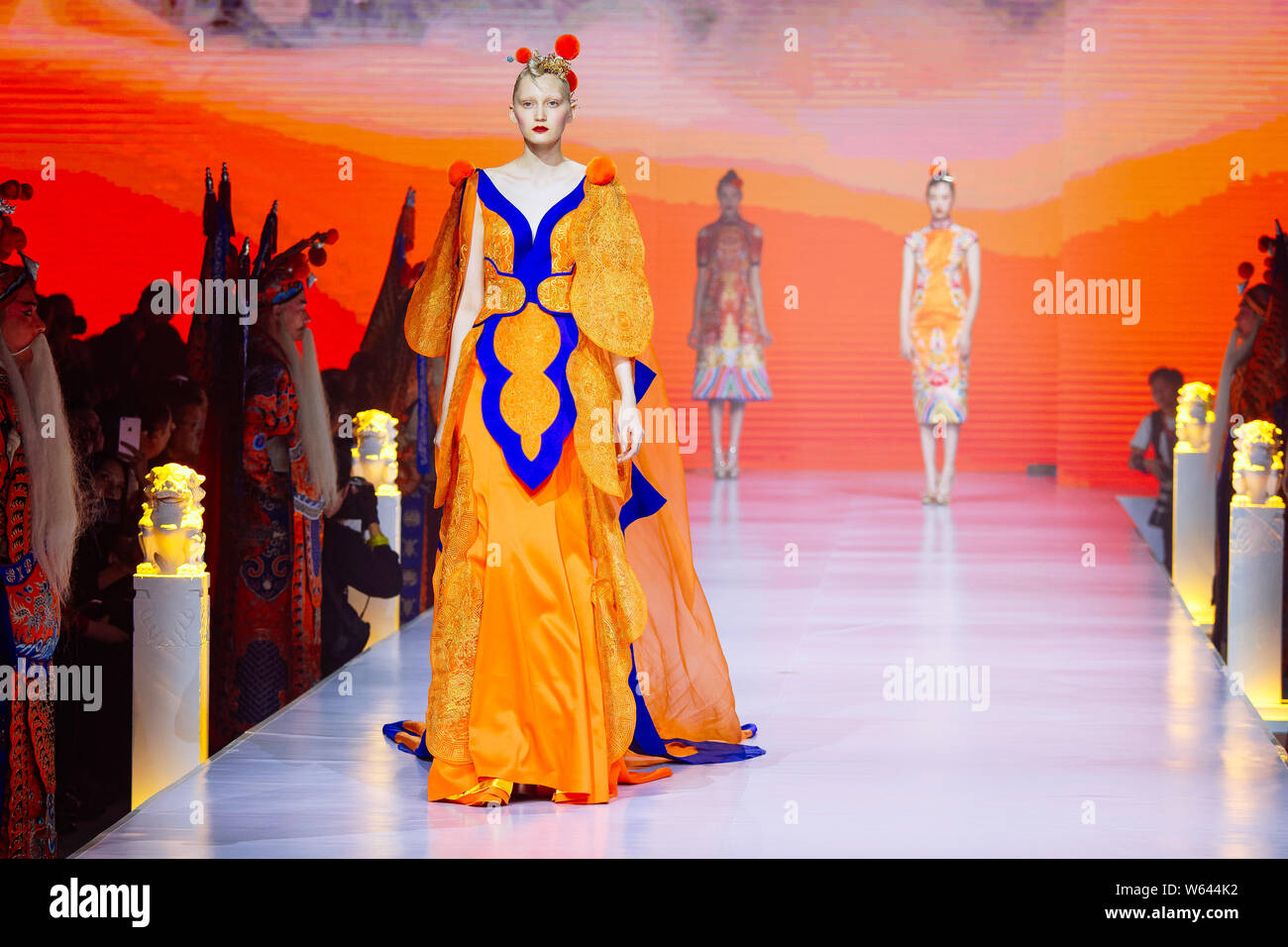 A model displays a new creation at an opera-themed fashion show during ...