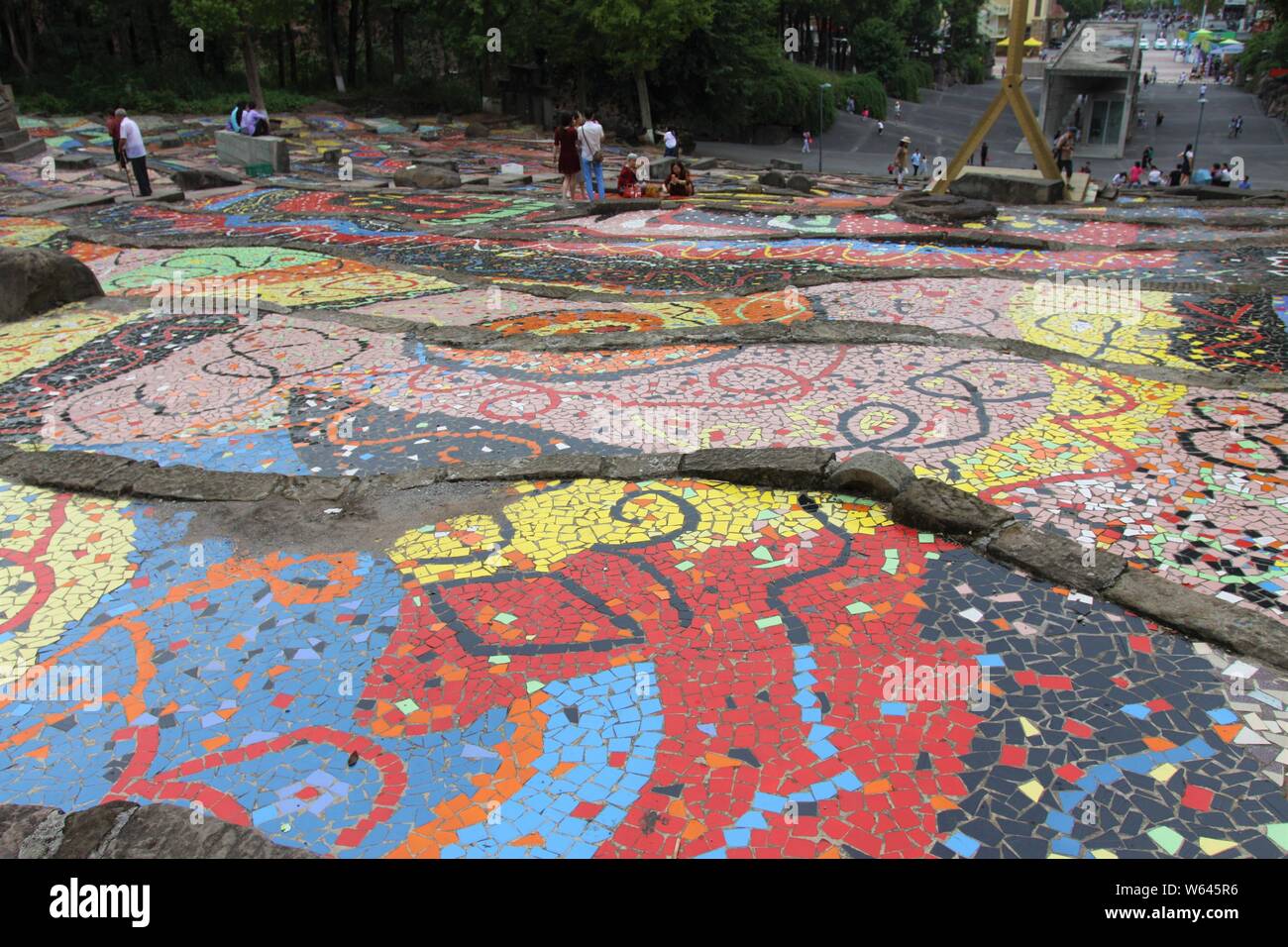Visitors walk on a colored rice terraces-like art installation at ...