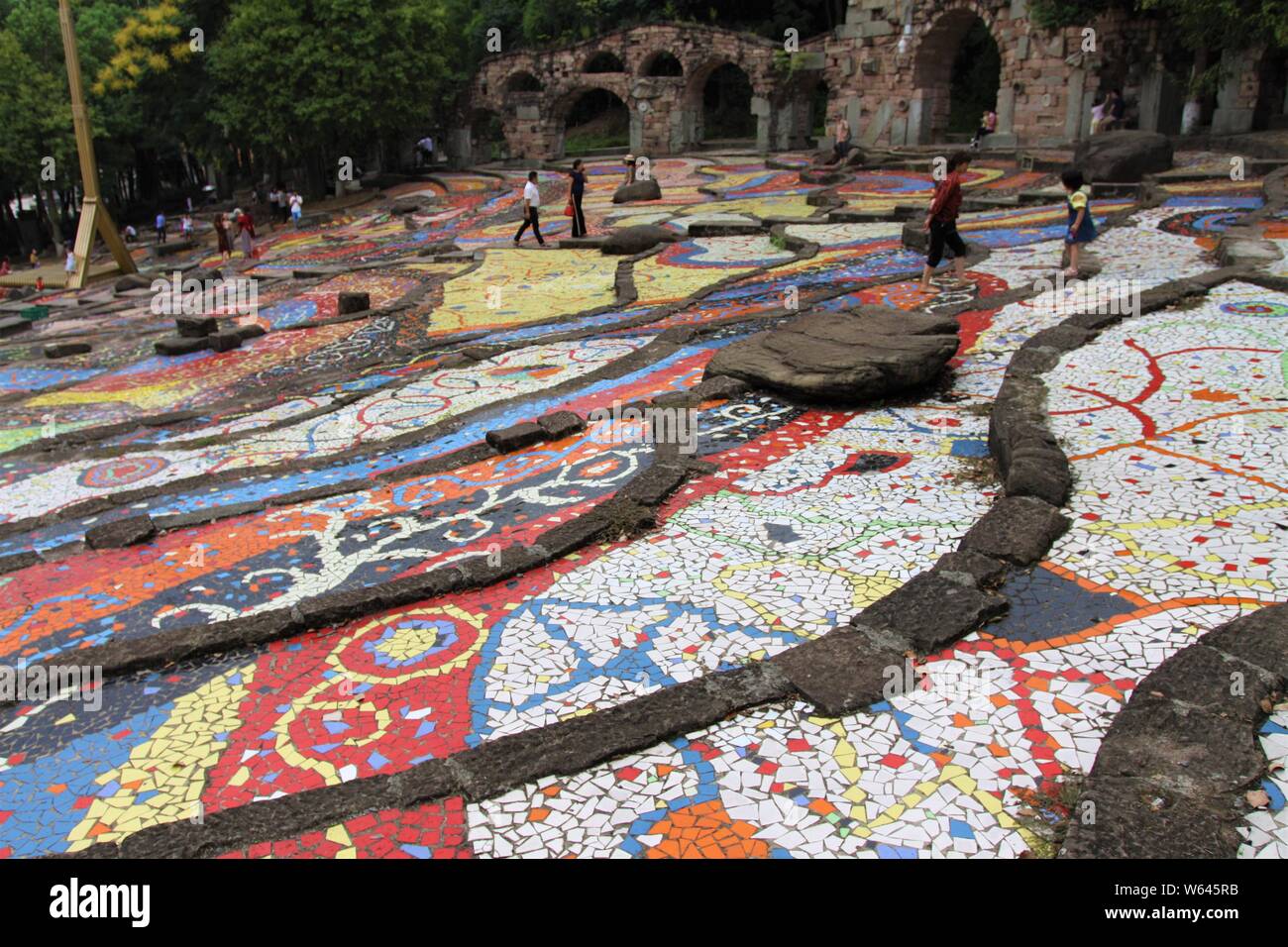 Visitors walk on a colored rice terraces-like art installation at ...