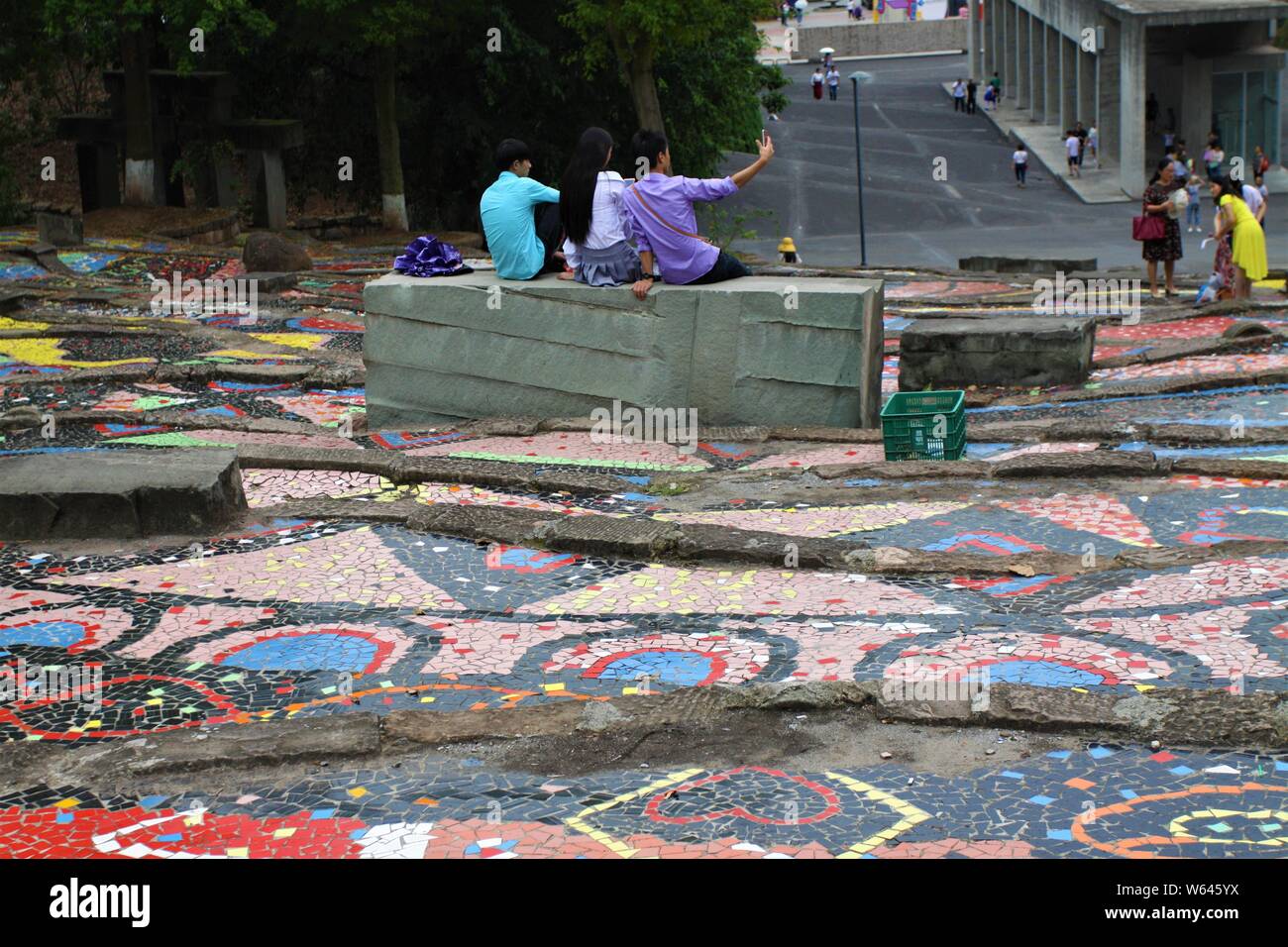 Visitors walk on a colored rice terraces-like art installation at ...