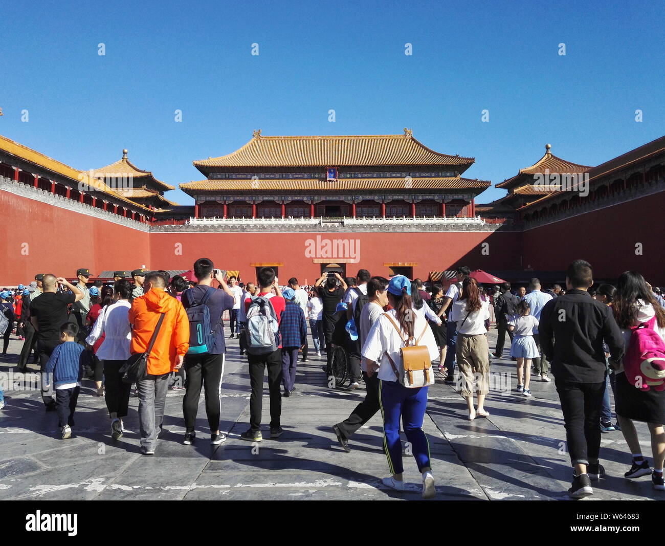 Tourists crowd the Palace Museum, also known as the Forbidden City ...