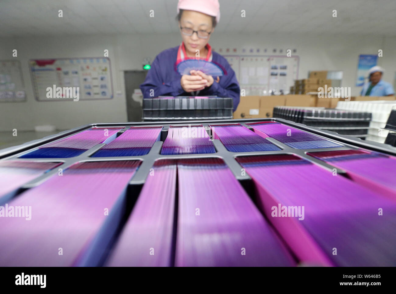 --FILE--A Chinese worker checks chips for electronic products at a ... --FILE--A Chinese worker checks chips for electronic products at a ...