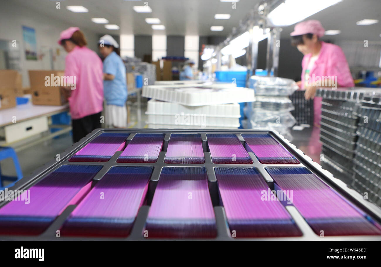 --FILE--Chinese workers check chips for electronic products at a ...