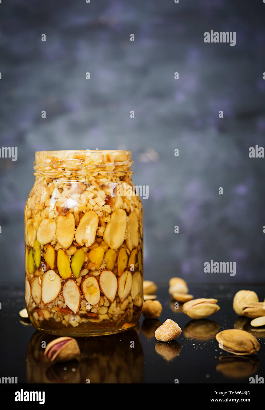 Different kinds of nuts on dark background Stock Photo - Alamy