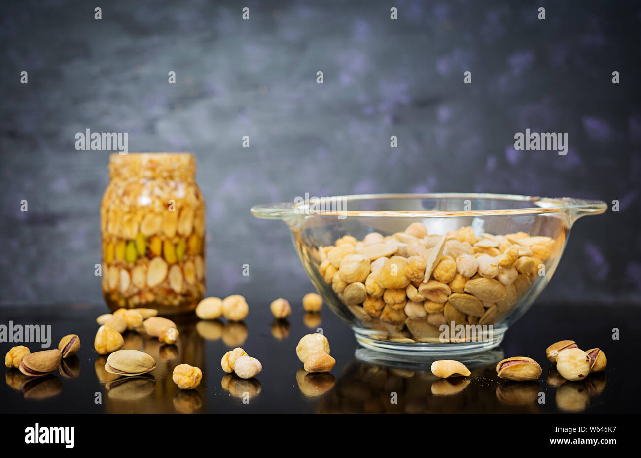 Different kinds of nuts on dark background Stock Photo - Alamy