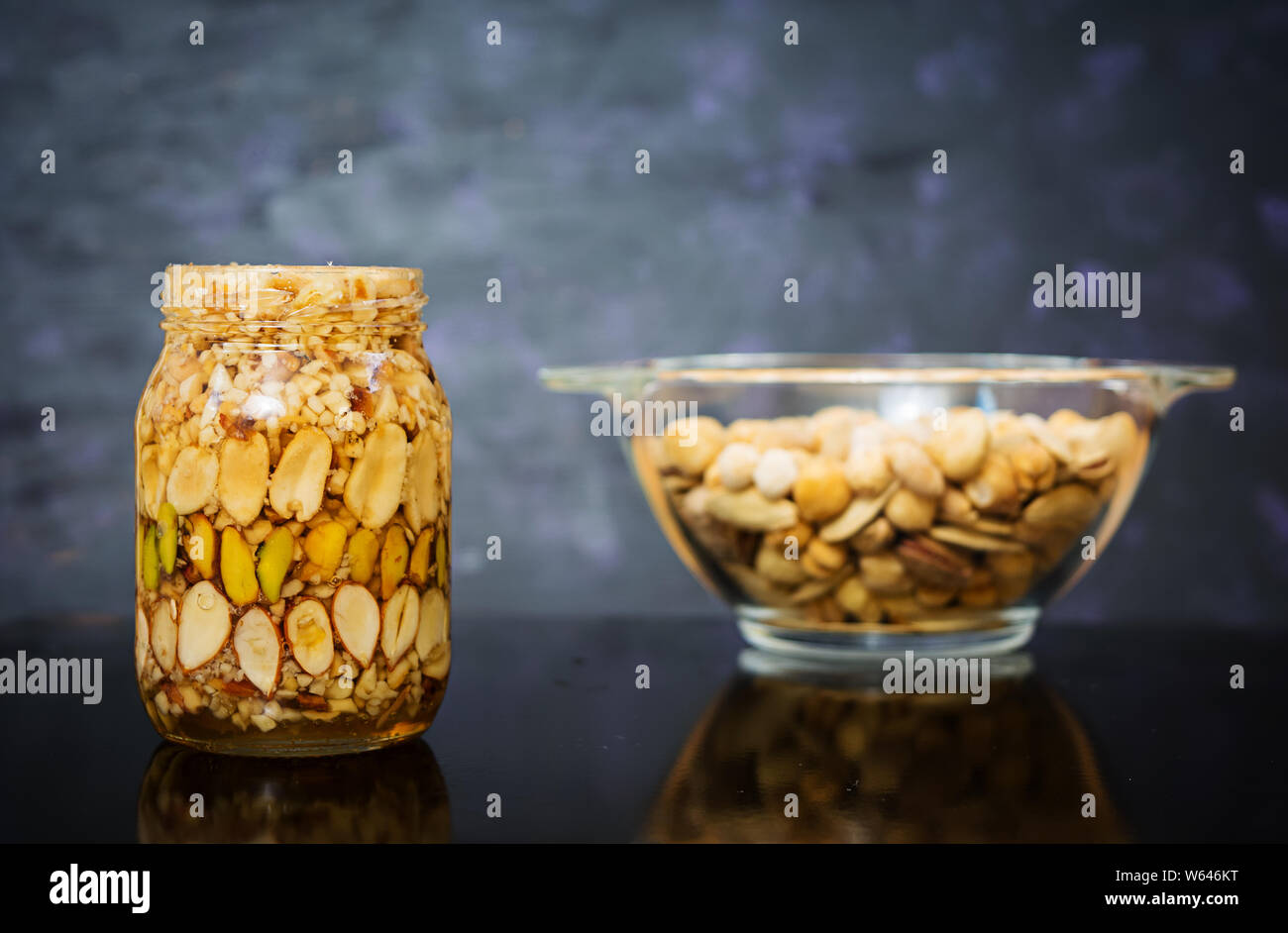 Different kinds of nuts on dark background Stock Photo - Alamy
