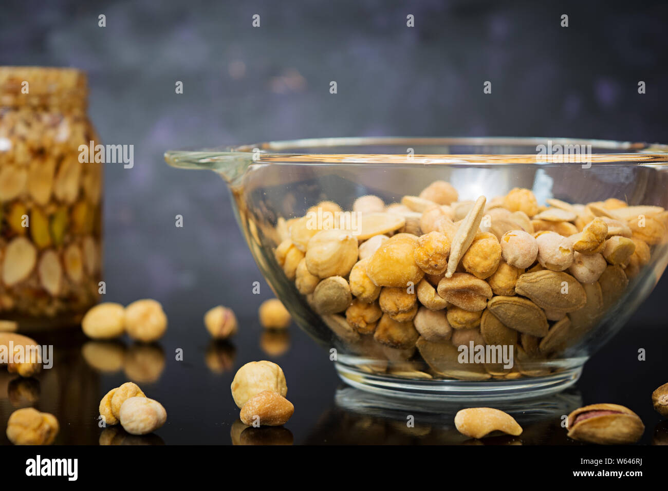 Different kinds of nuts on dark background Stock Photo - Alamy