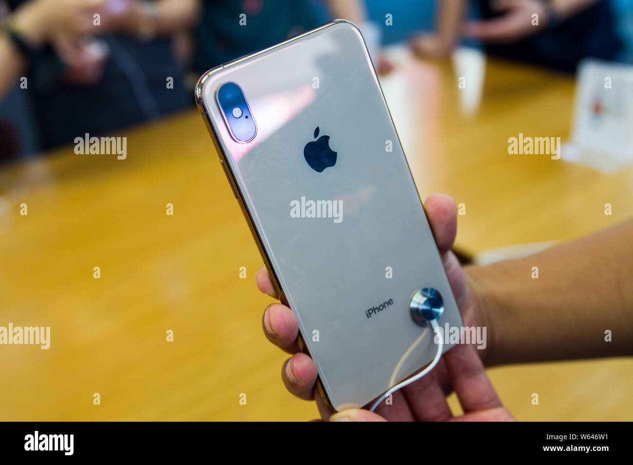 A Chinese customer tries out an iPhone XS Max smartphone at the Huaihai ...