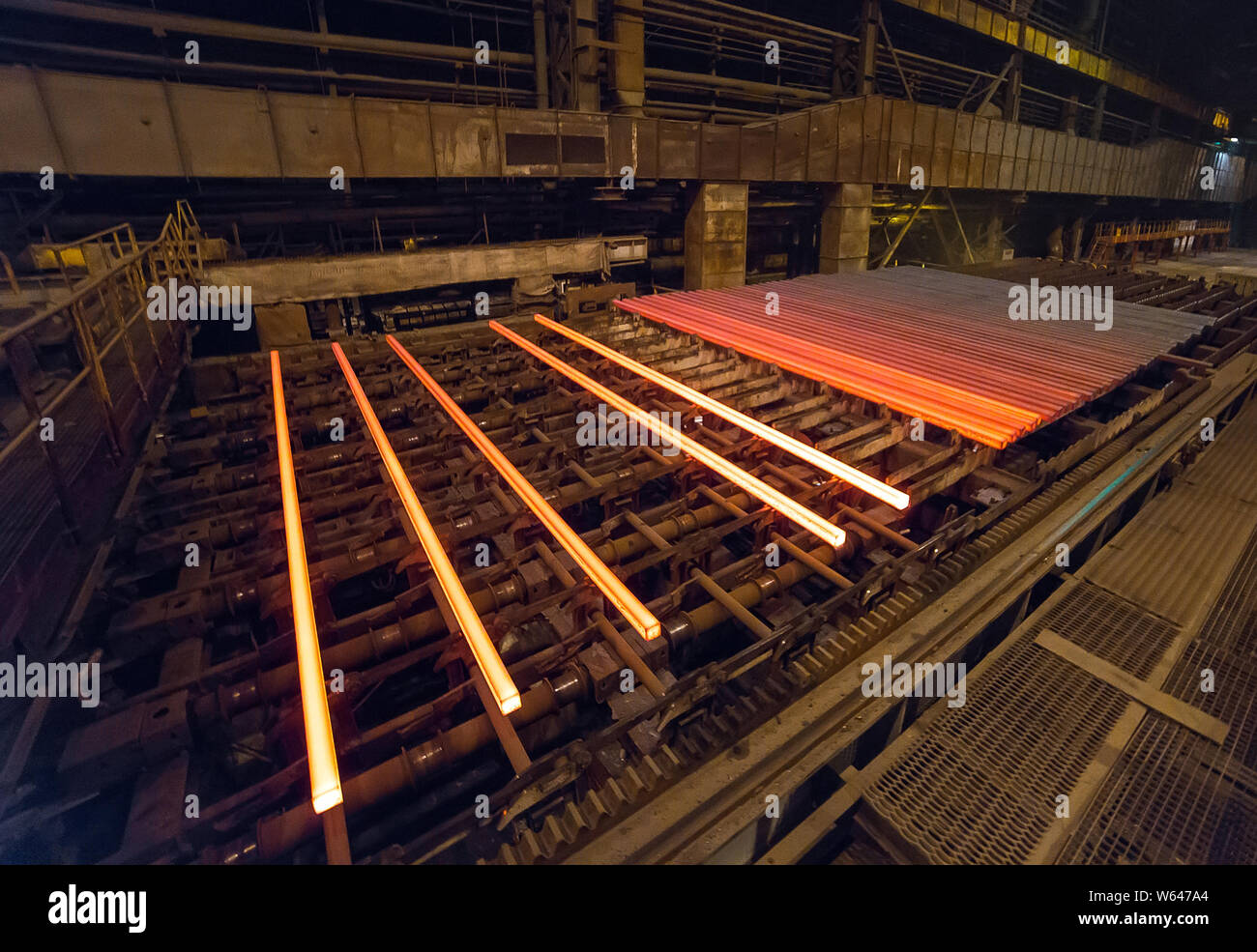Hot square steel bloom on the roll-table Stock Photo - Alamy