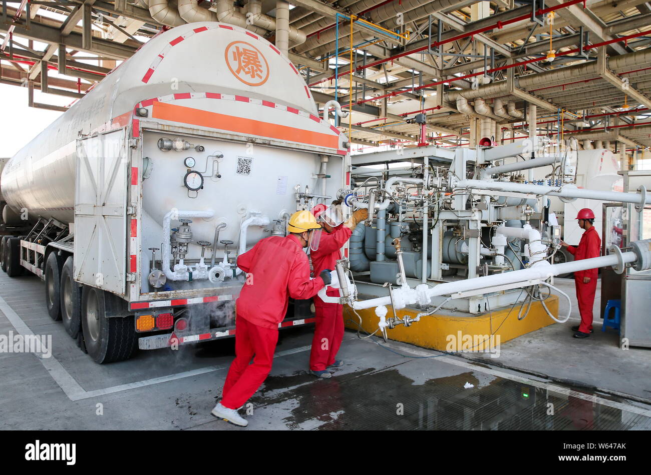 Chinese workers load a tanker with liquefied natural gas (LNG) at the ...