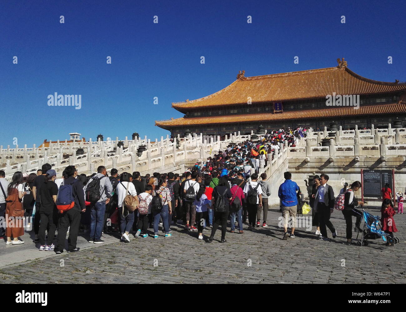Tourists crowd the Palace Museum, also known as the Forbidden City ...