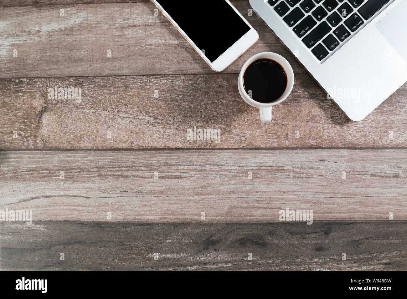 wood office desk with computer and smart phone with coffee cup Stock ...