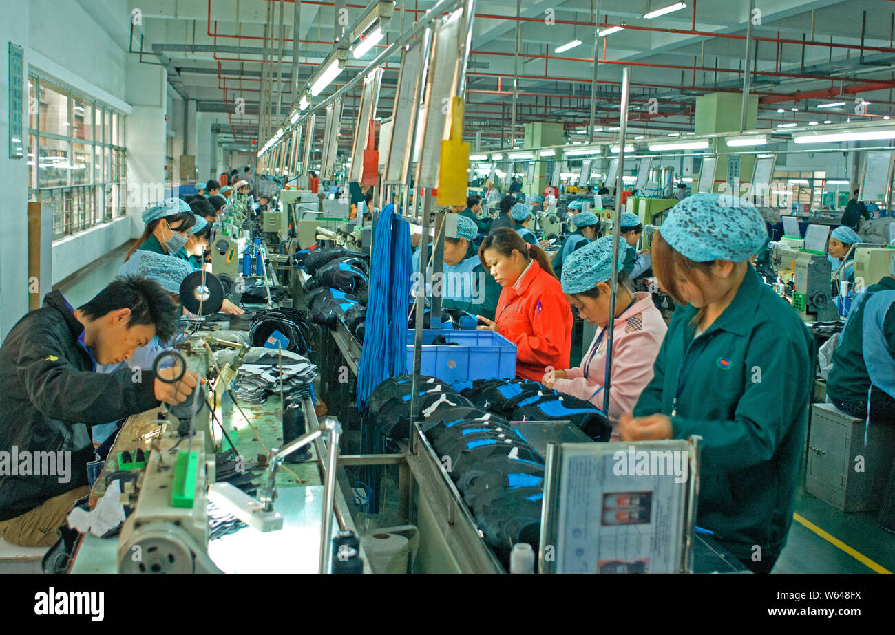 --FILE--Chinese workers produce shoes at a factory in Dongguan city ...