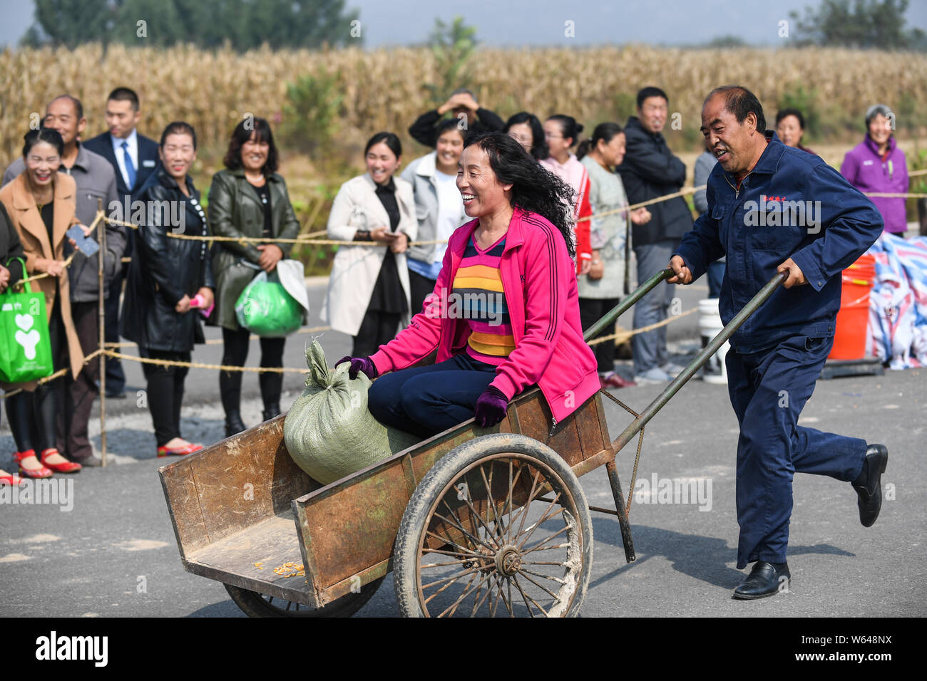 A Chinese farmer carts his wife and stuffed sack in the wife-carting ...