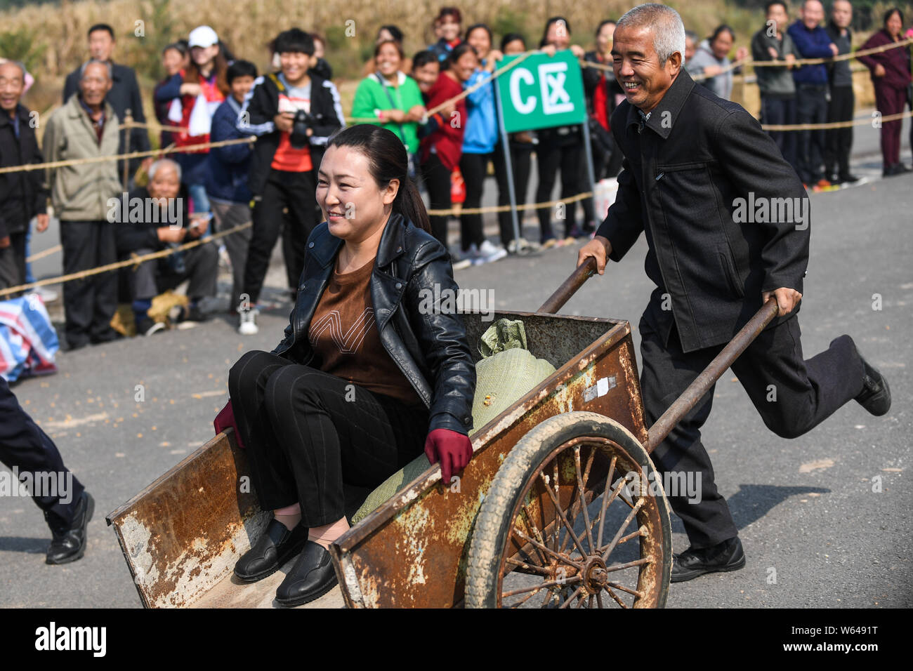 A Chinese farmer carts his wife and stuffed sack in the wife-carting ...