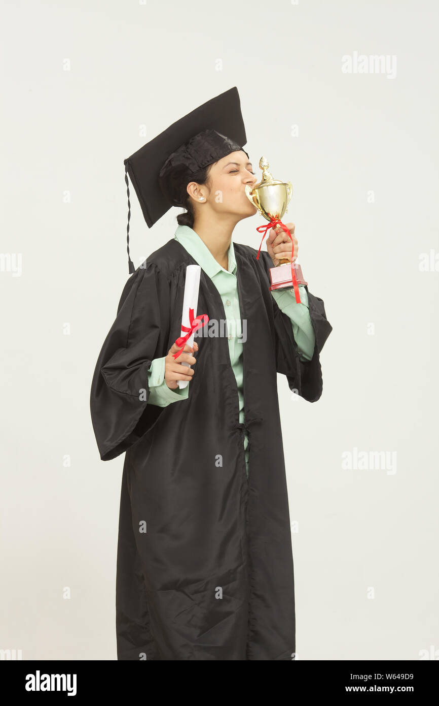 College student kissing her graduation trophy Stock Photo - Alamy