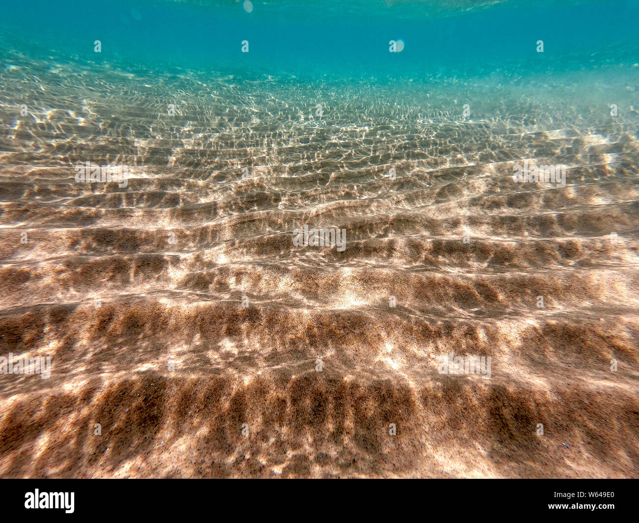 underwater background with sandy sea bottom. Beautiful texture of the ...