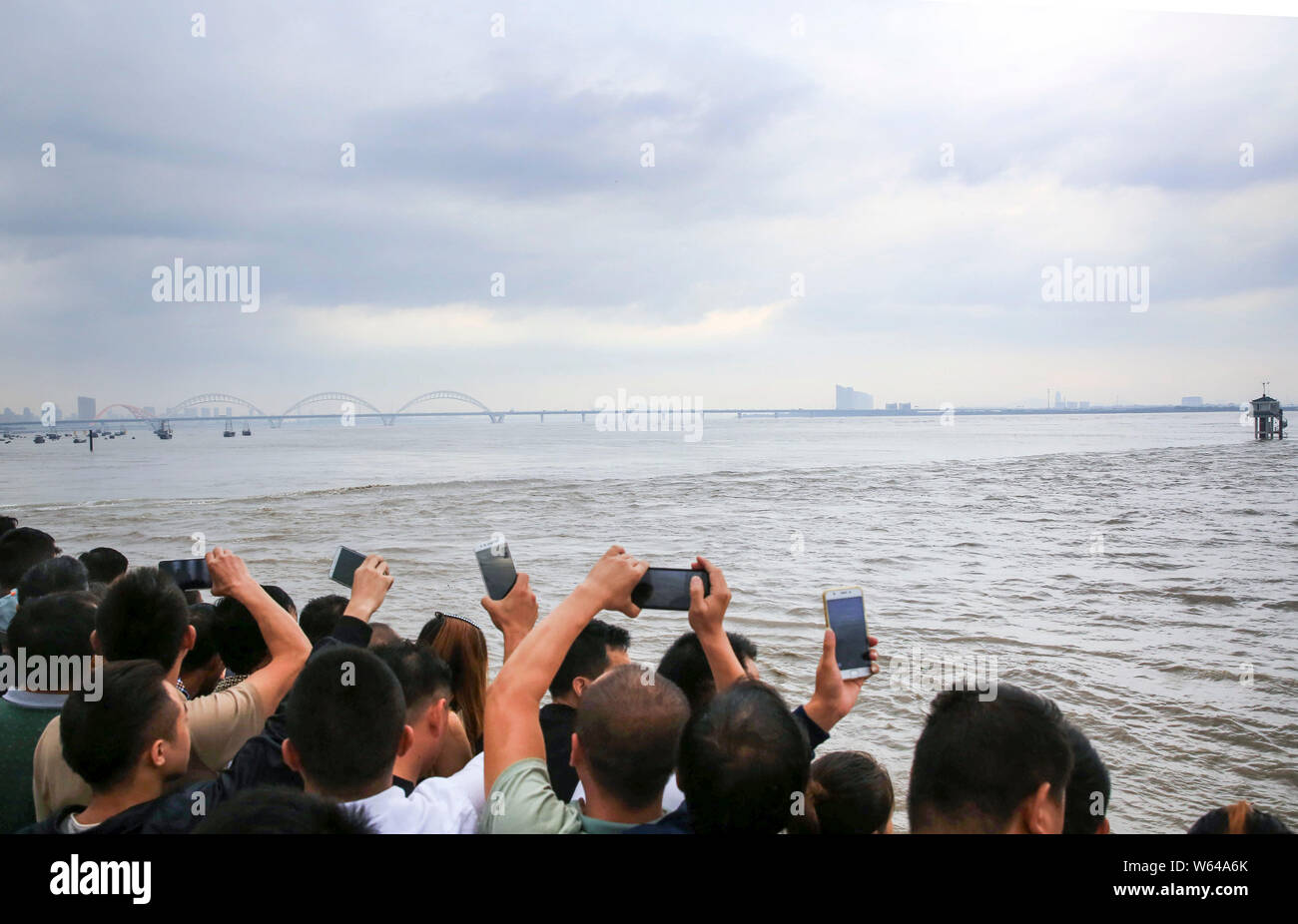 Visitors and local residents watch waves from one-line tidal bore of ...