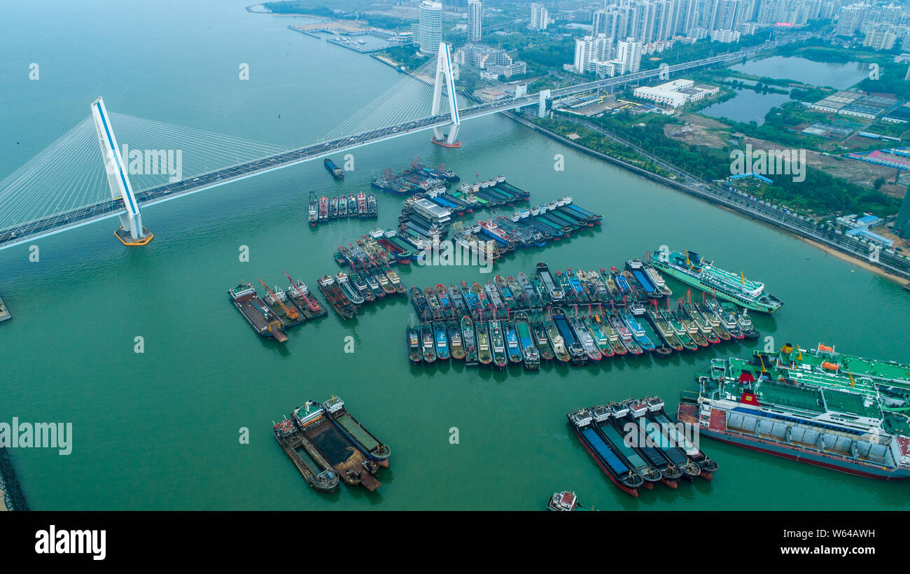 Fishing boats are docked at a harbor in preparation for Typhoon Barijat ...